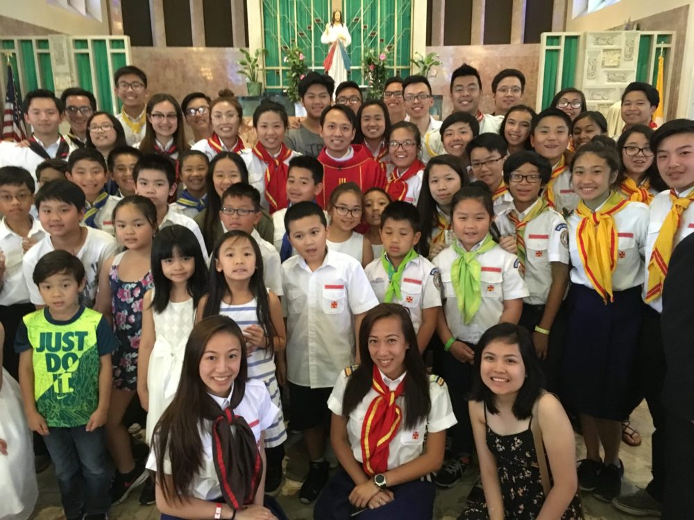 The youth group at St. Paul the Apostle Parish crowd newly ordained ...