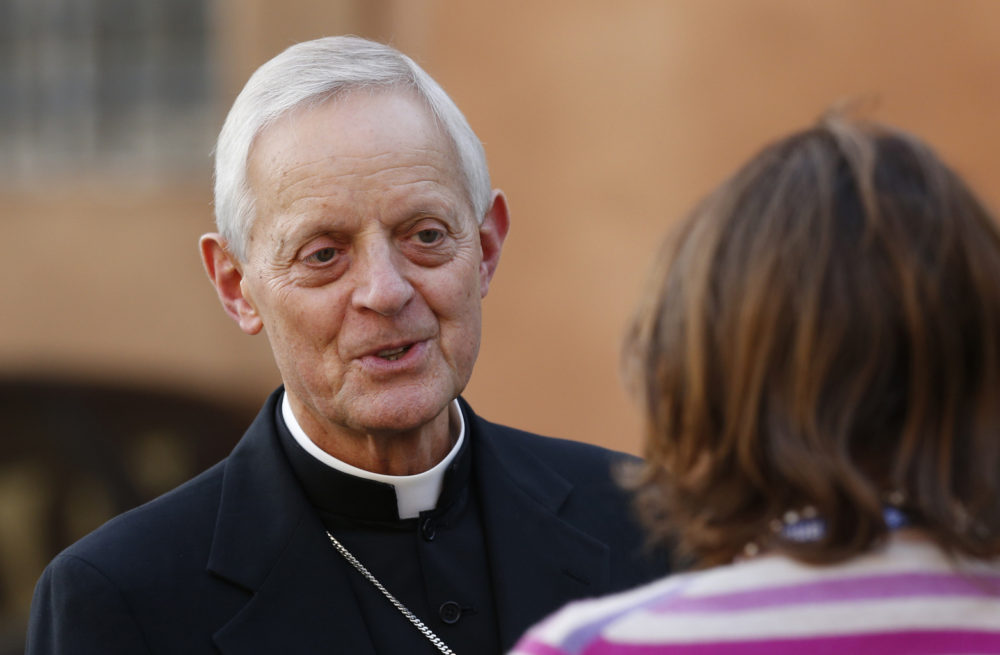 Cardinal Donald W. Wuerl of Washington speaks with a journalist as he ...