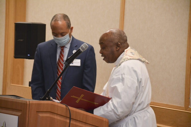 Father Donatus Ironuma offers a blessing for Montez Carter, president ...
