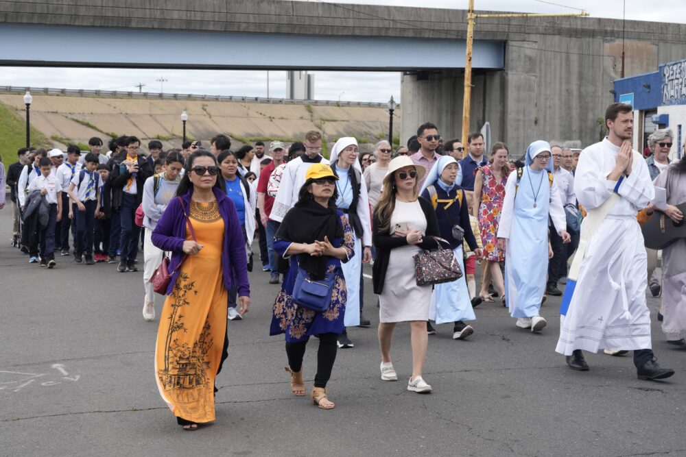 People participate in a Eucharistic procession in Bridgeport, Conn ...