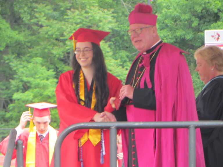 Salutatorian Hannah Fanelli poses for a picture with Bishop William D ...