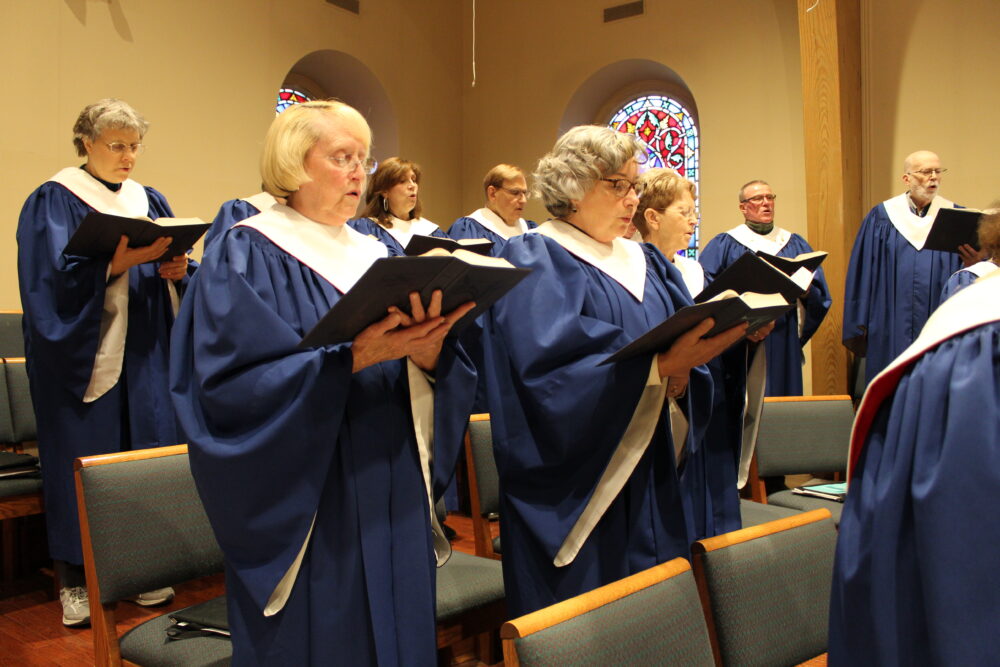 Members of the St. Cecilia Adult Choir sing during a recent Mass at the ...